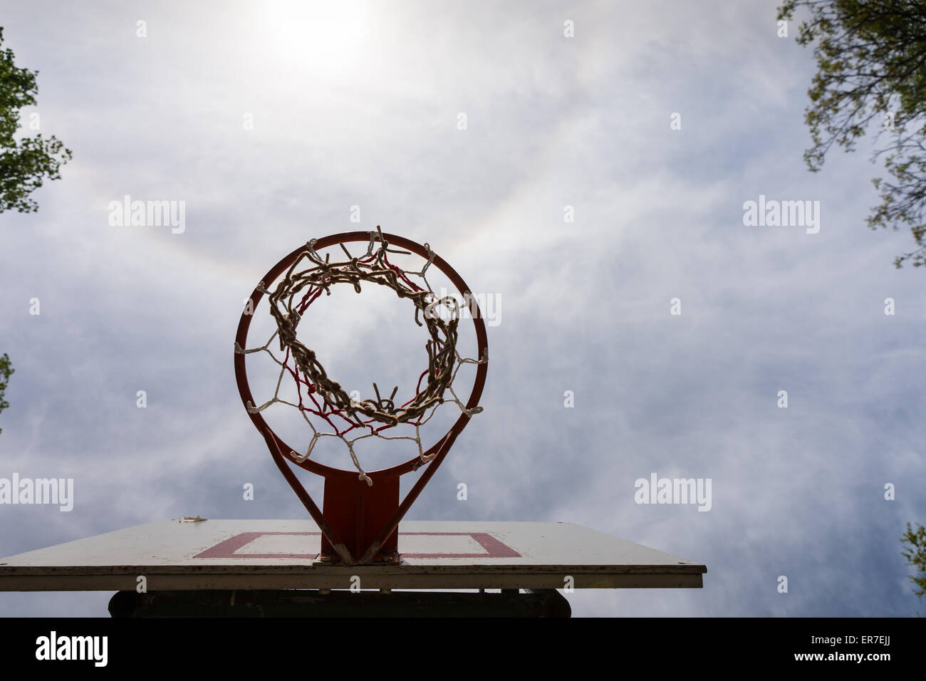 Low Angle View of Basketball Backboard, Basket, and Net Against Sunny ...