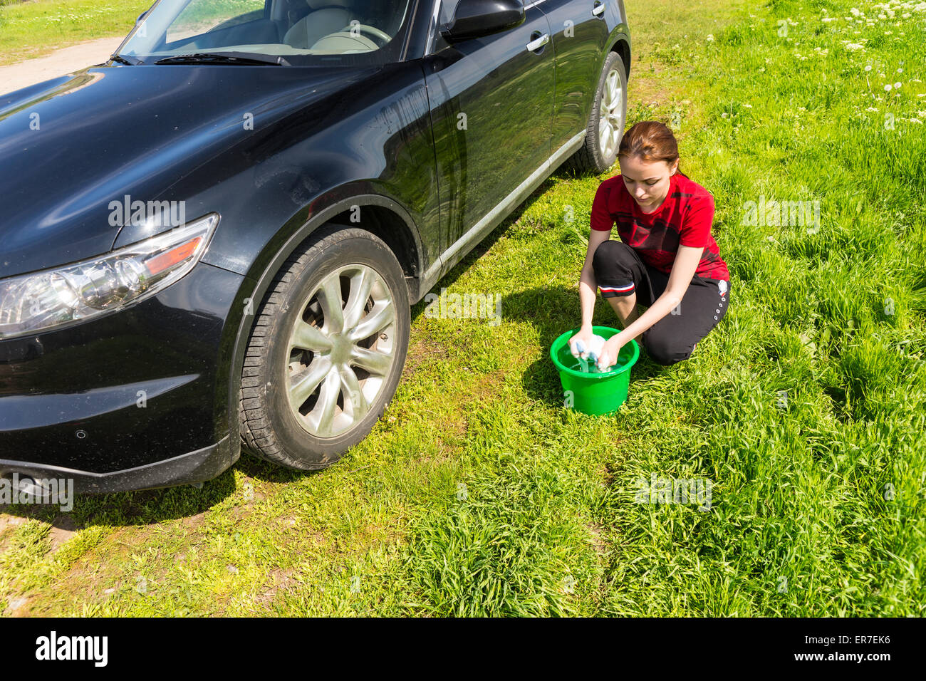High Angle View of Woman with Green Bucket Wringing Out Soapy Sponge ...