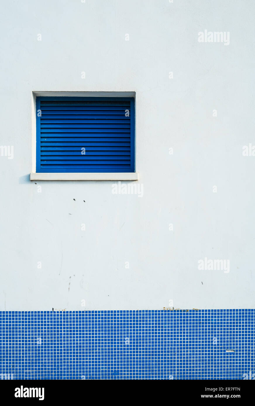 Blue window on a blue and white wall Stock Photo - Alamy
