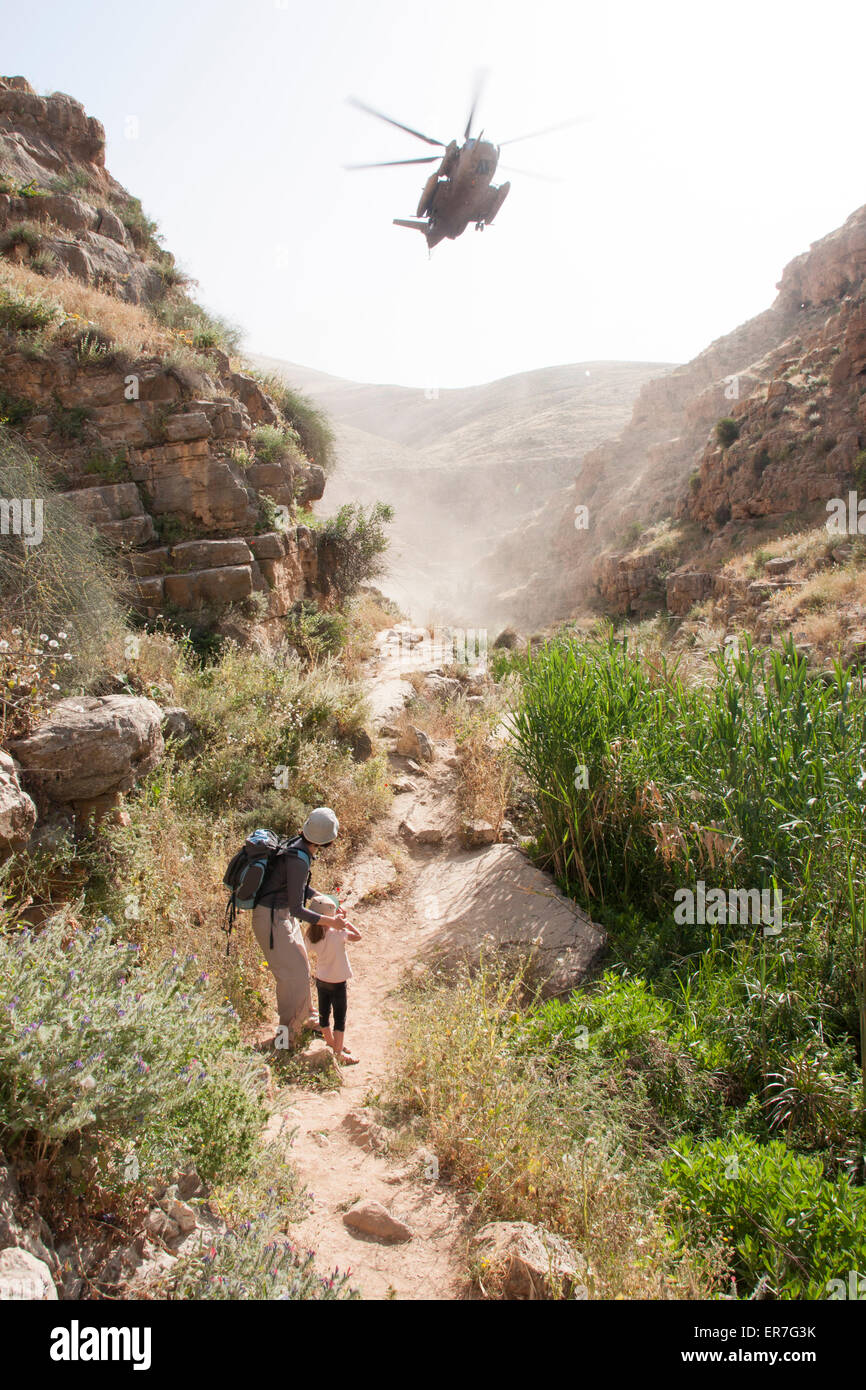 Israel. A Woman and a girl look at an approaching Military Rescue ...