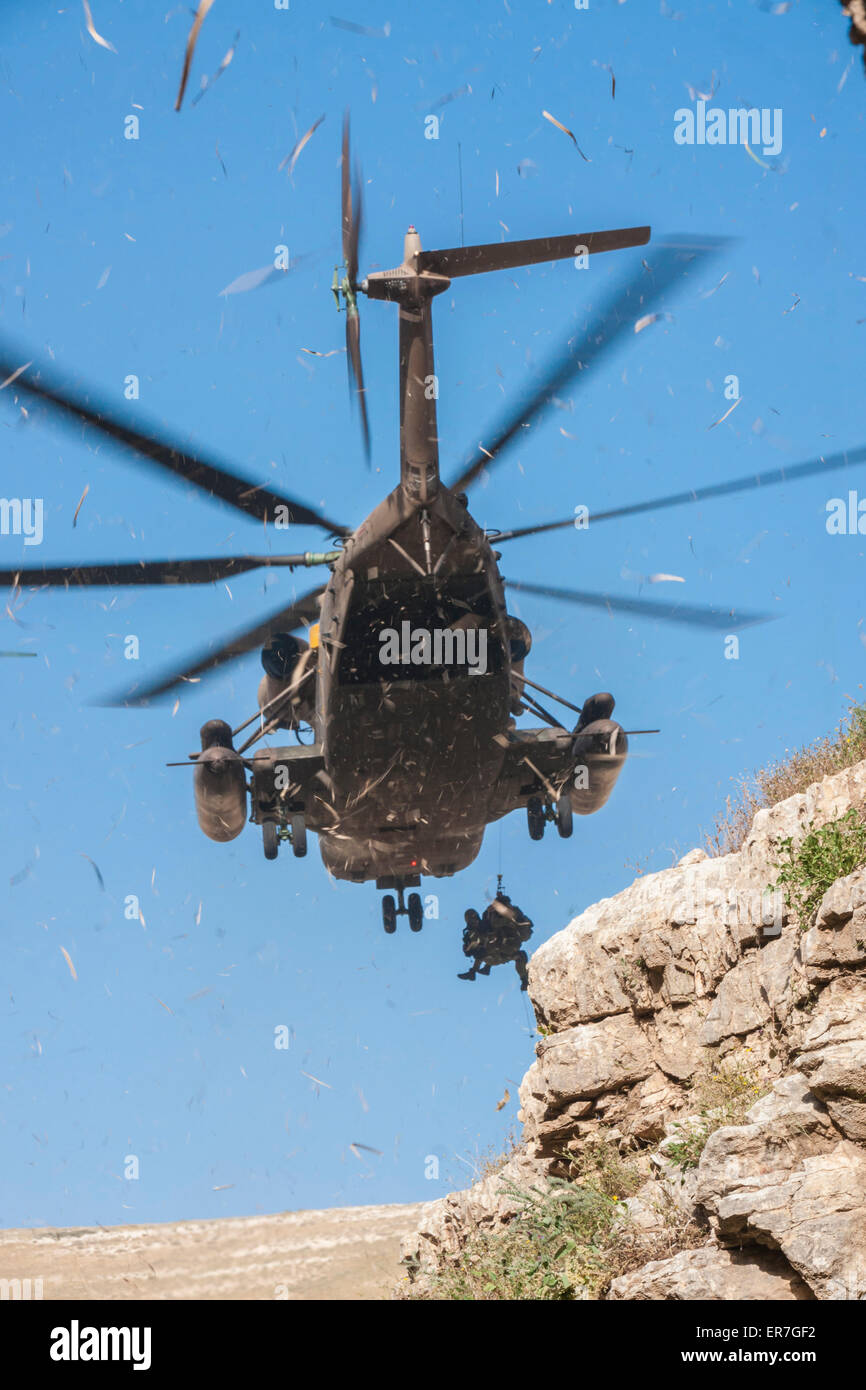 Kelt Canyon, Judean Desert, Israel. A Soldier rappels from a hovering ...