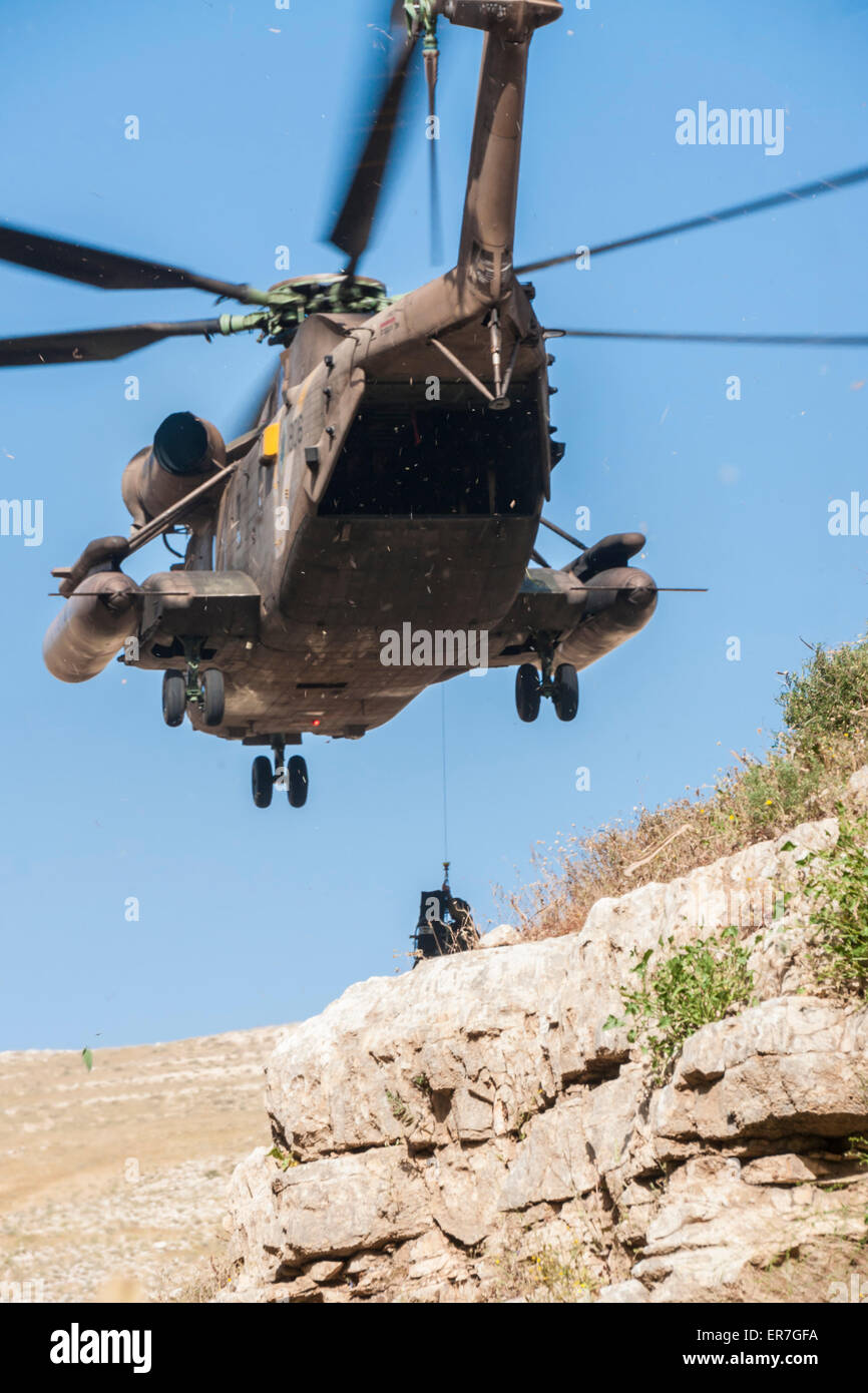 Kelt Canyon, Judean Desert, Israel. A Soldier rappels from a hovering ...