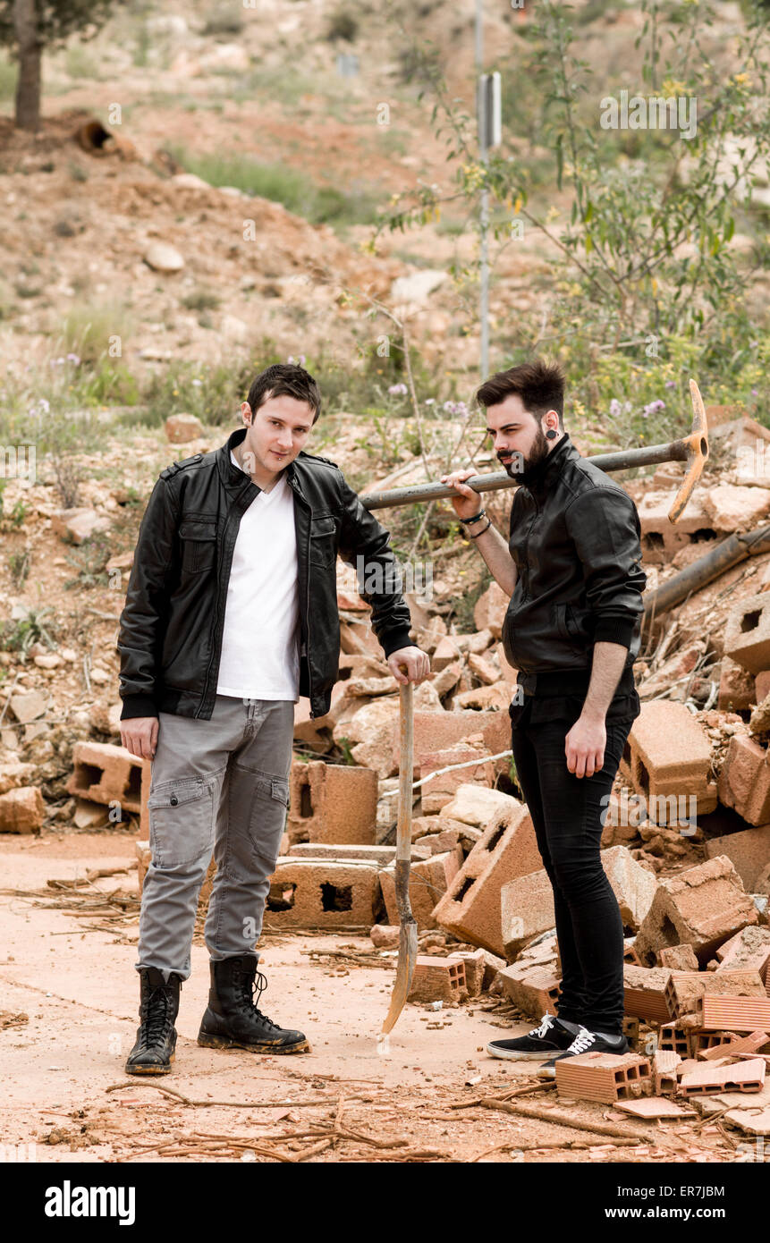 Two guys with tools amidst rubble on a demolition site Stock Photo - Alamy