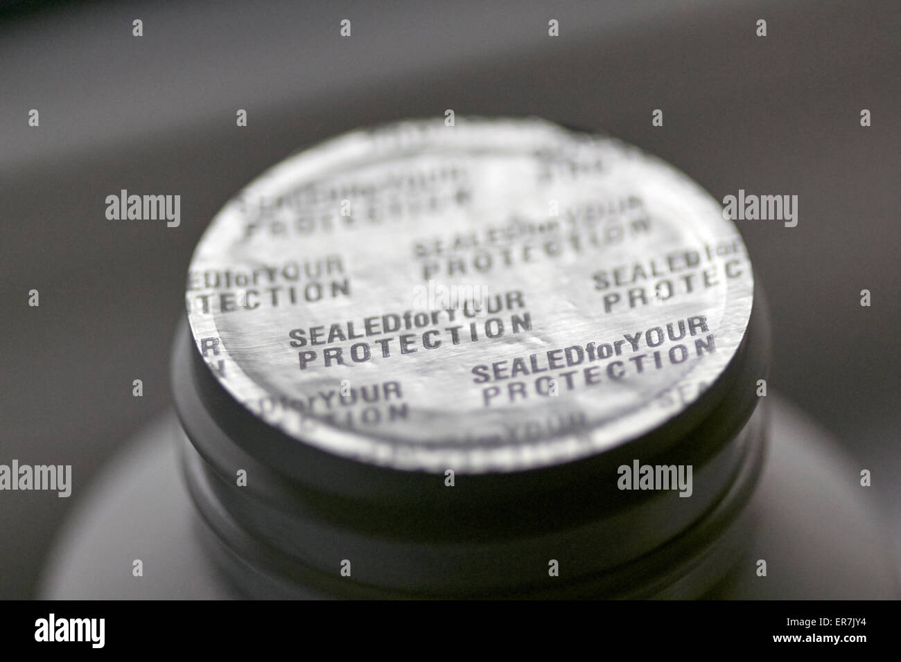foil sealed tamper proof top on a bottle of pills Stock Photo - Alamy