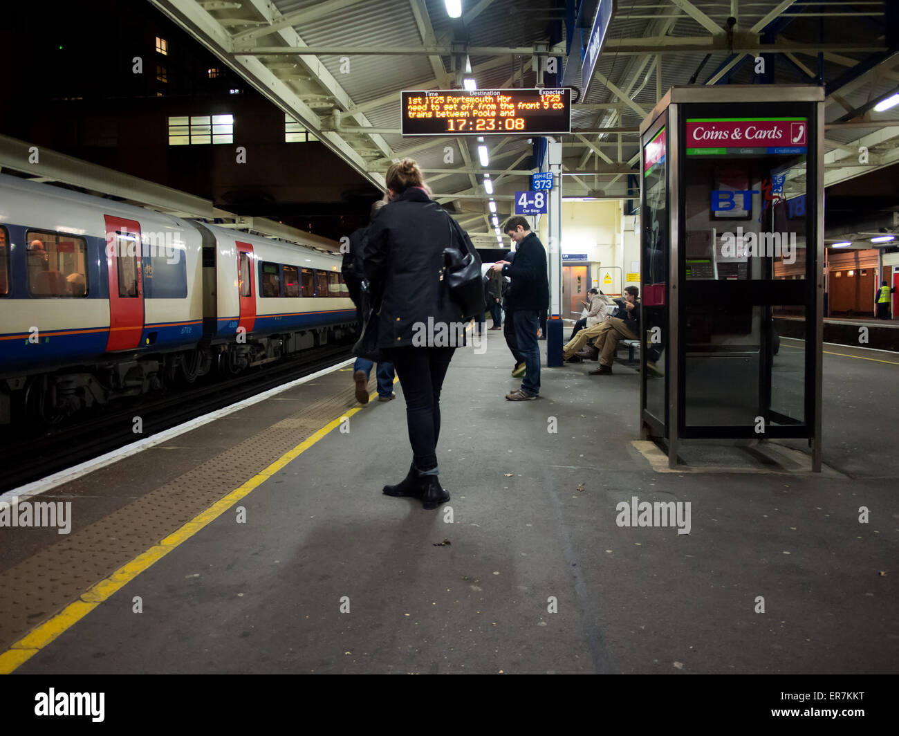 passengers standing on a platform at Woking station at night Stock ...