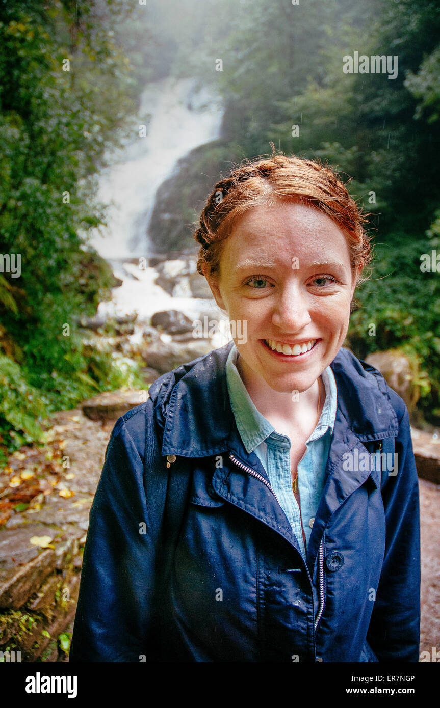 Woman looking up at waterfall hi-res stock photography and images - Alamy