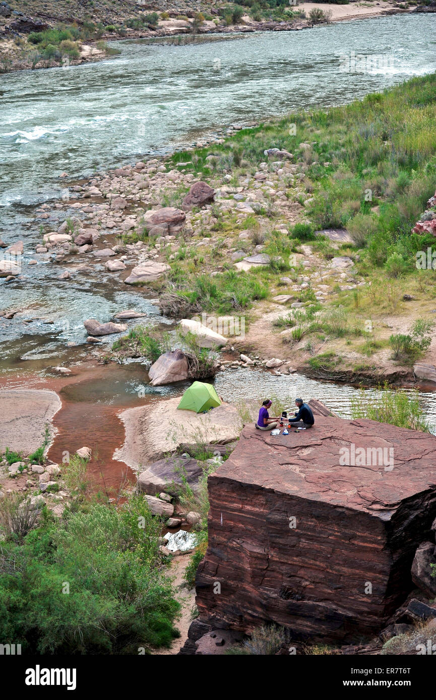 Hikers cook dinner on a cliff-pinched patio above camp and the Colorado ...