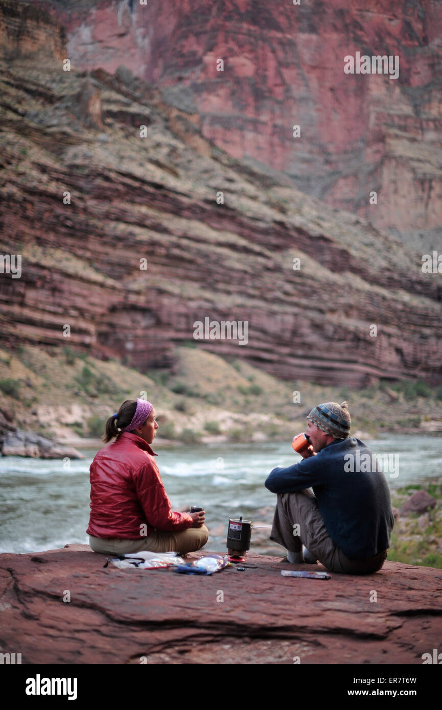 Hikers cook dinner on a cliff-pinched patio above camp and the Colorado ...
