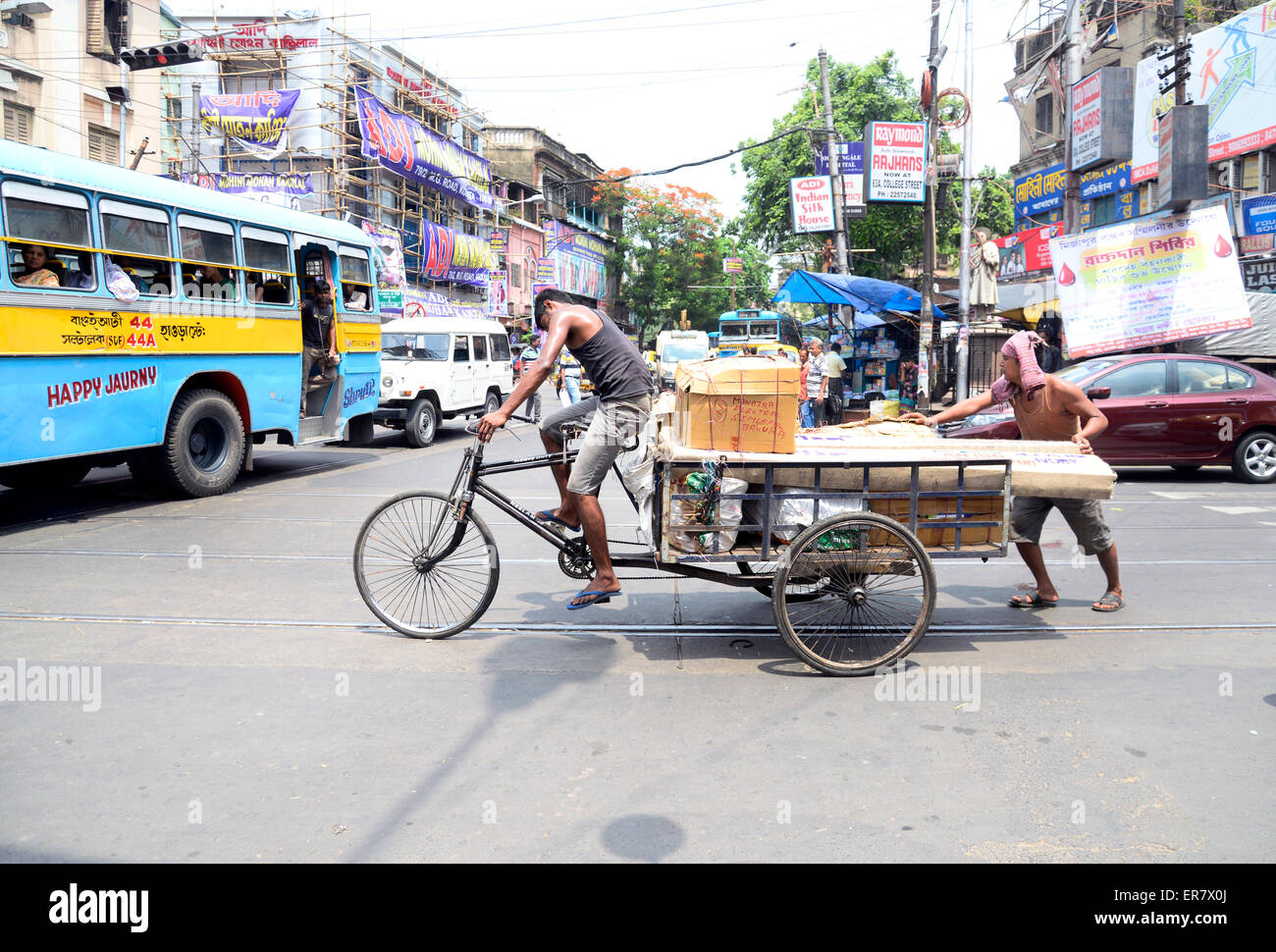 Kolkata, India. 28th May, 2015. Cycle van puller and labor pull goods ...