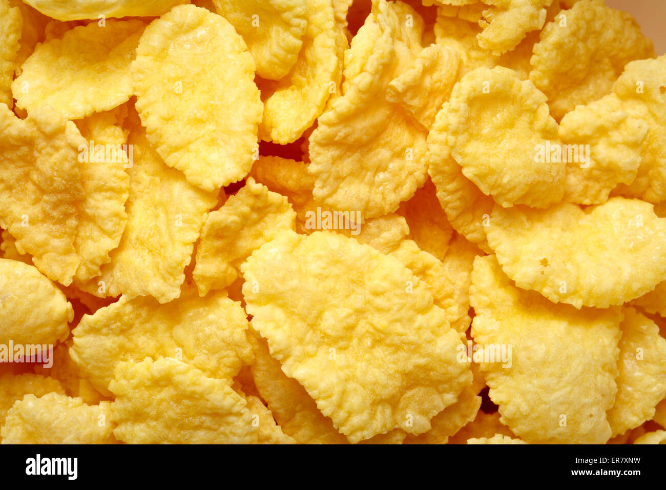 Yellow corn flakes cereal background in closeup Stock Photo - Alamy