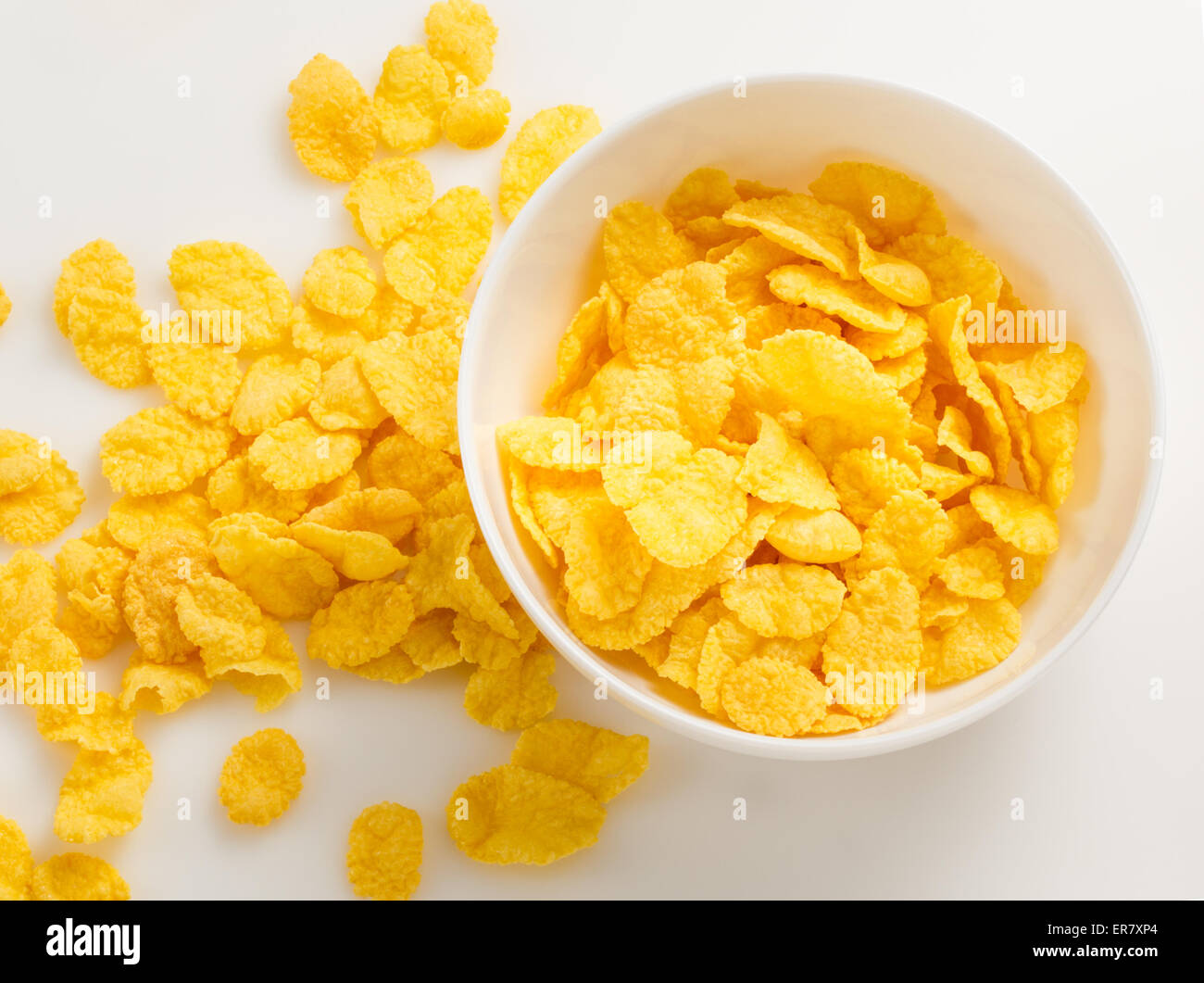 Yellow corn flakes in the white bowl Stock Photo - Alamy