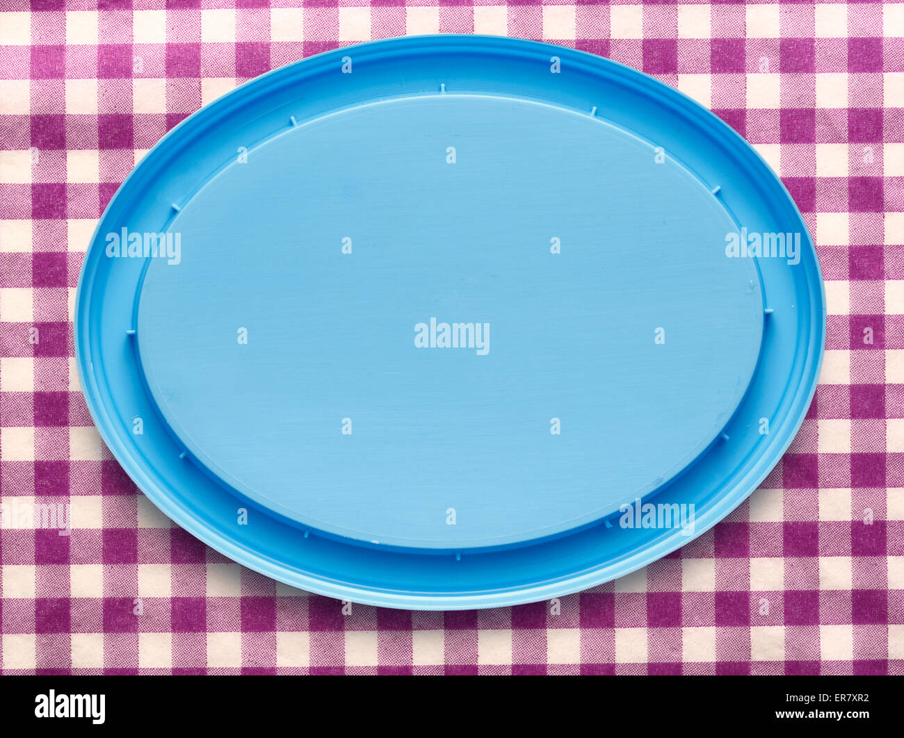 Blue plastic cover on checked background closeup Stock Photo - Alamy