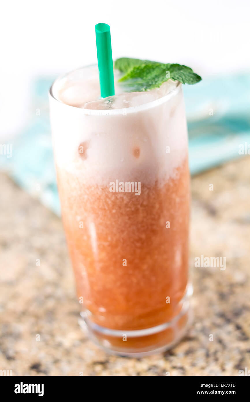 Refreshing thai iced tea garnished with fresh mint leaves Stock Photo ...
