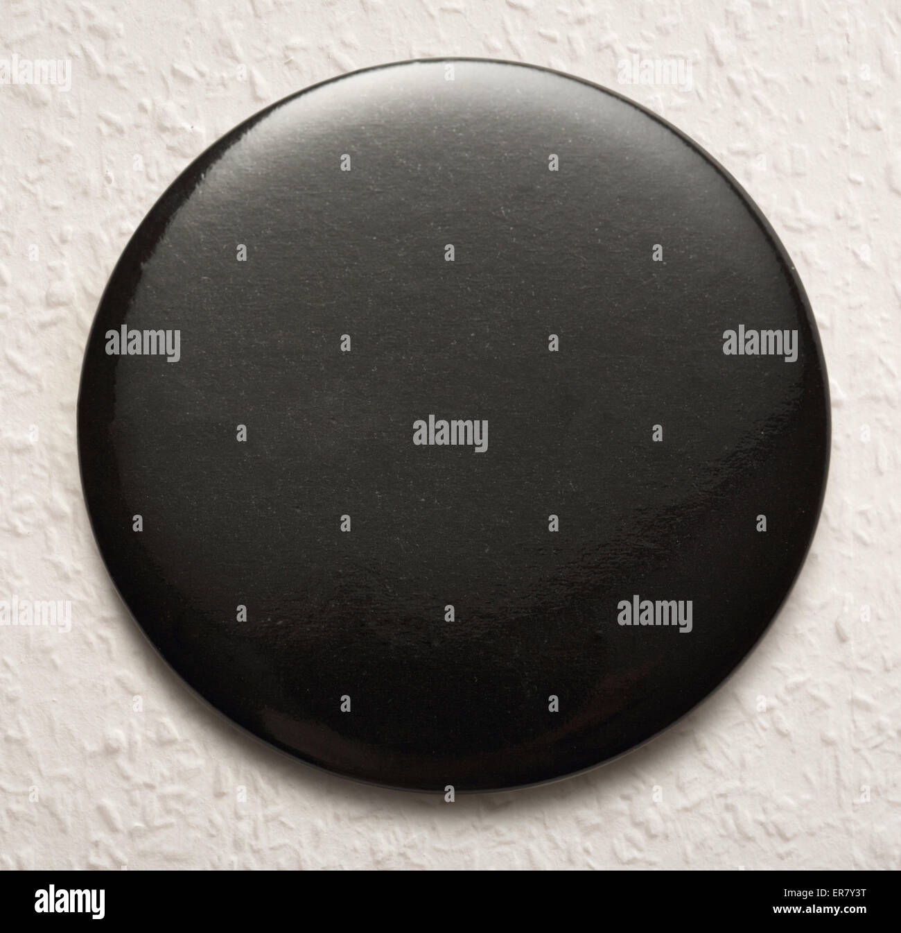 Blank single black round badge in closeup Stock Photo - Alamy