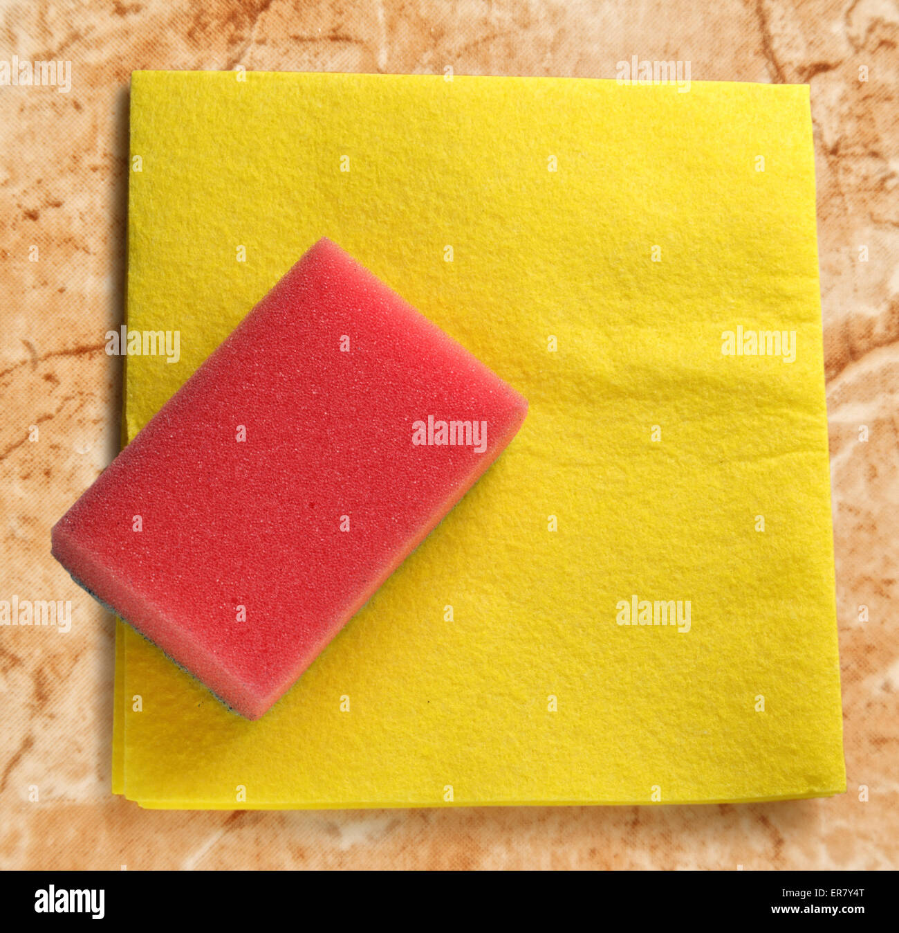 Yellow duster and red sponge in closeup Stock Photo - Alamy