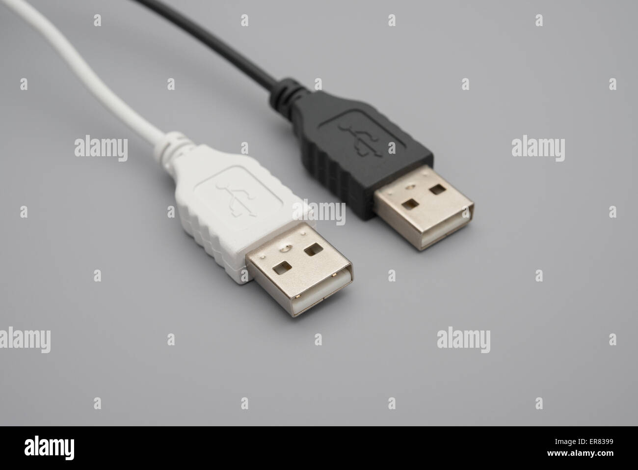 black and white usb cables on grey background Stock Photo - Alamy