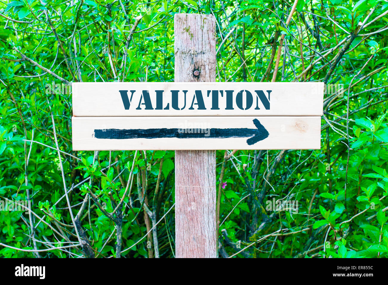 VALUATION written on Directional wooden sign with arrow pointing to the ...