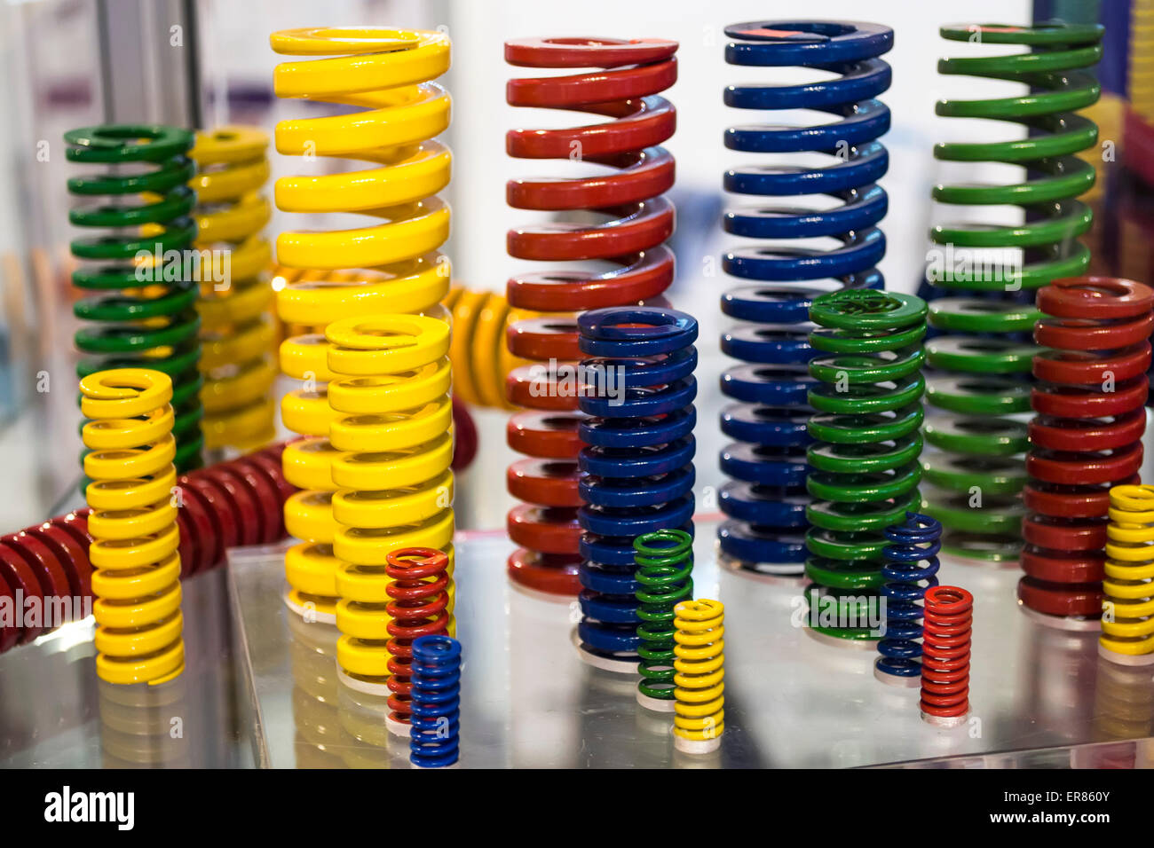 Bunch of vividly colored metallic coils in different sizes on display ...