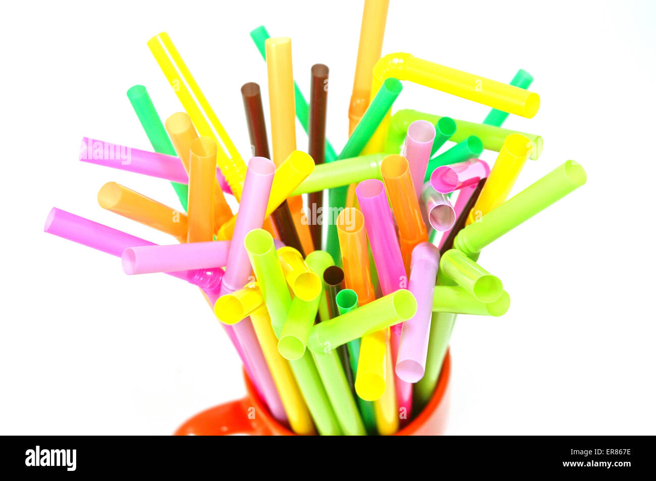 Multi colours plastic tubes in an orange cup isolated Stock Photo - Alamy
