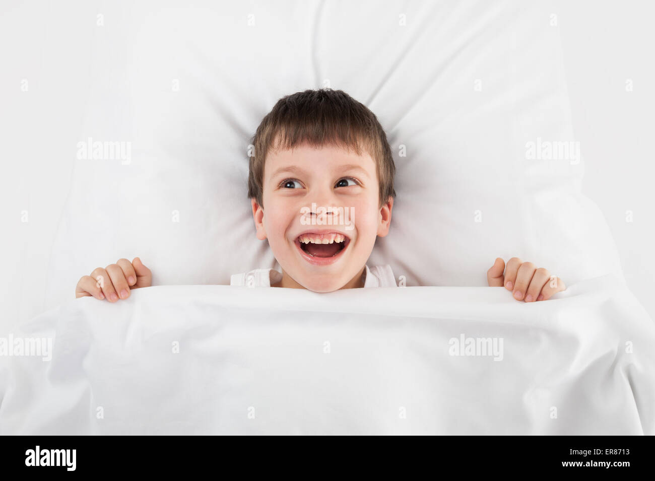 cheerful boy in white bed Stock Photo - Alamy cheerful boy in white bed Stock Photo - Alamy