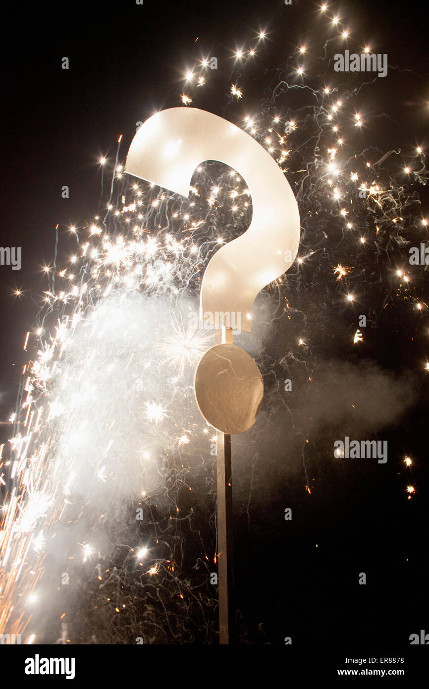 Question mark on pole with fireworks at night Stock Photo - Alamy