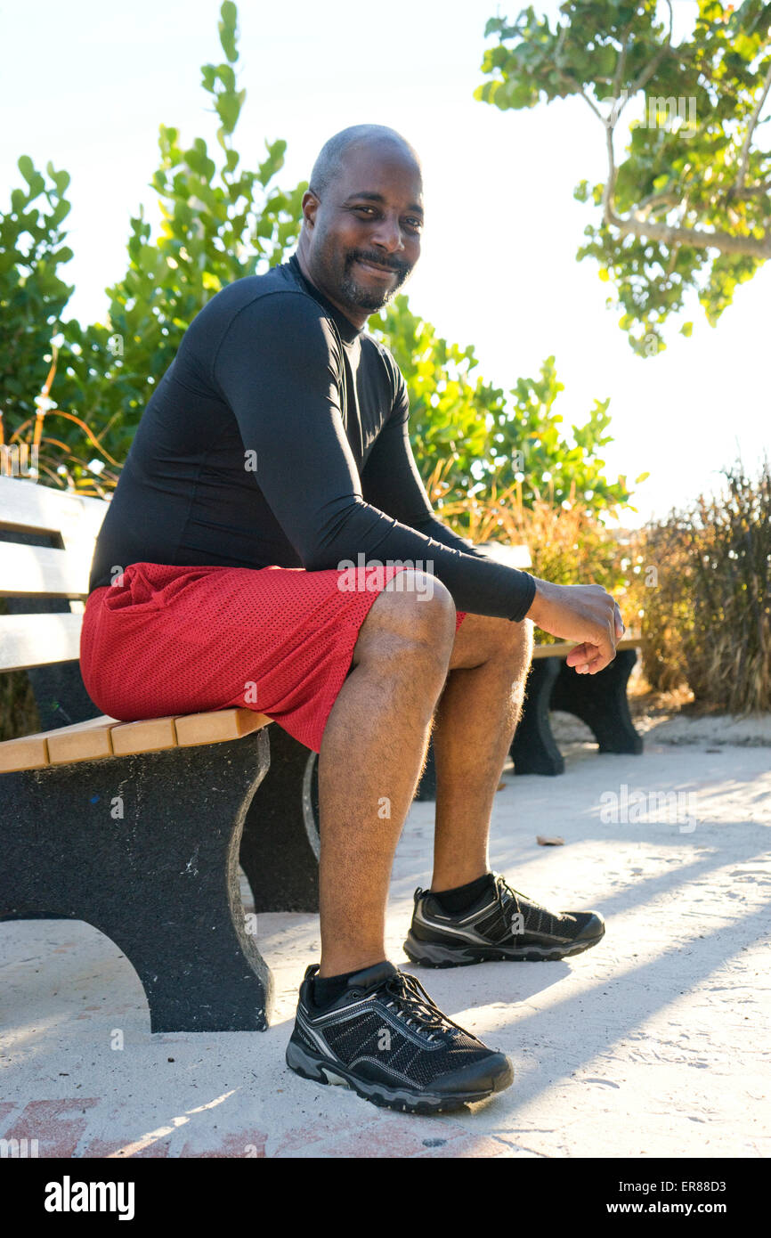 Man sitting on a park bench Stock Photo - Alamy
