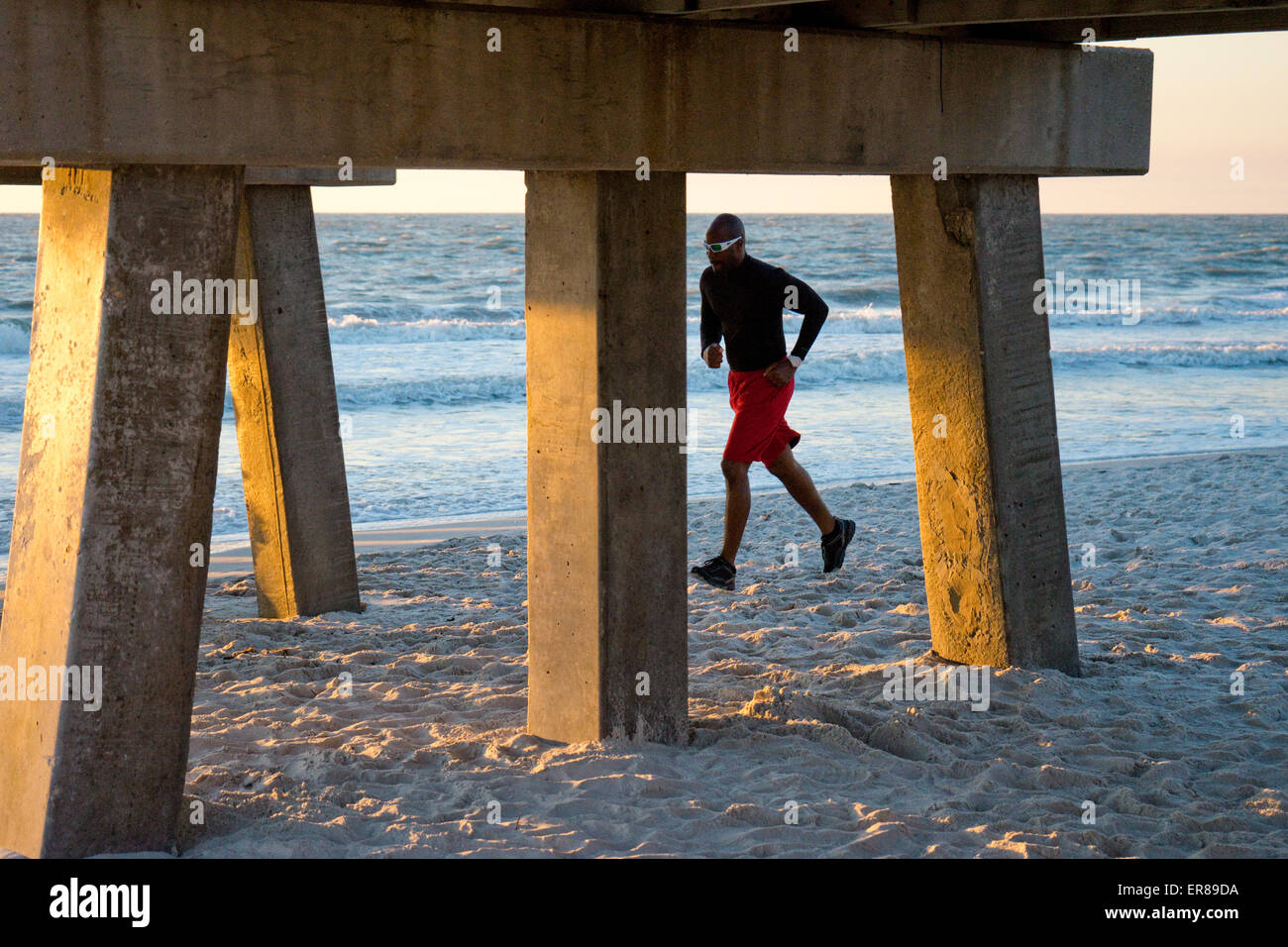 Person jogging on beach hi-res stock photography and images - Alamy