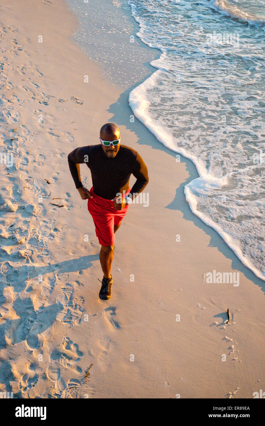 Man running on the beach Stock Photo - Alamy