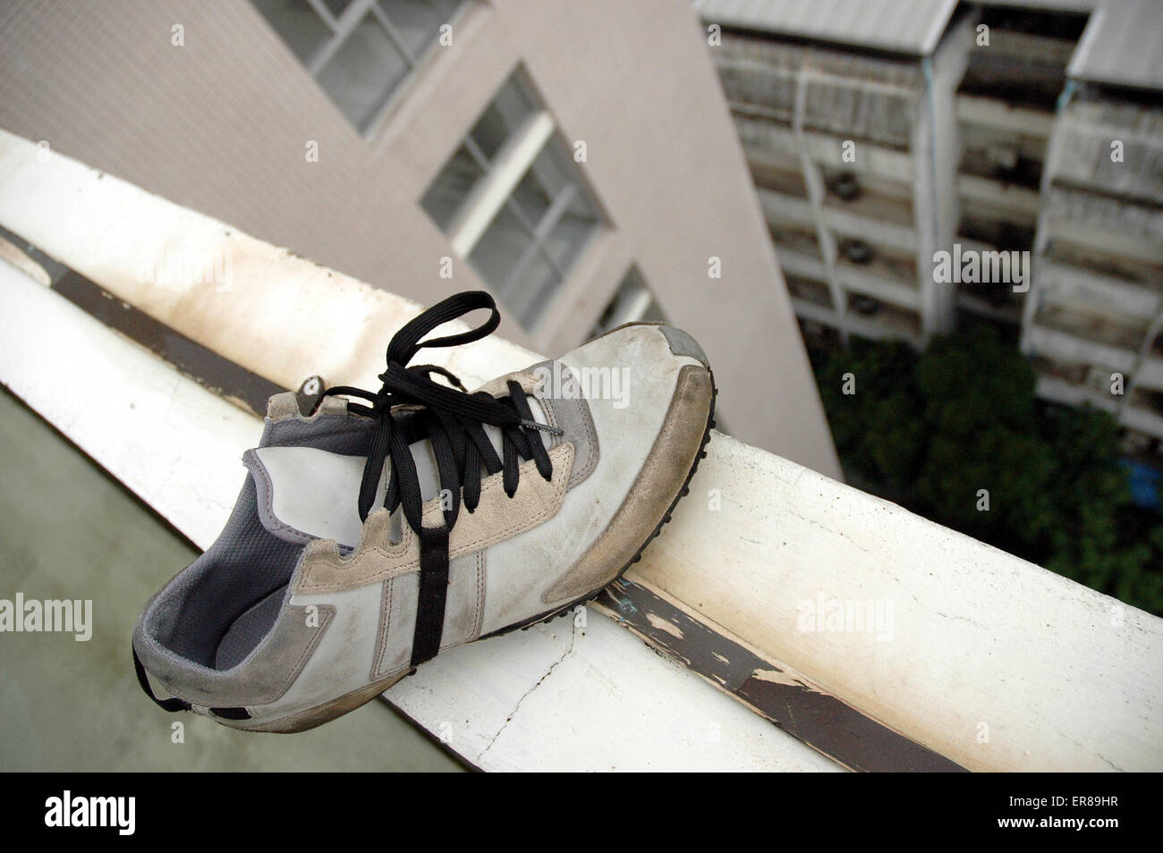 leftover shoe at the edge of a building roof Stock Photo - Alamy