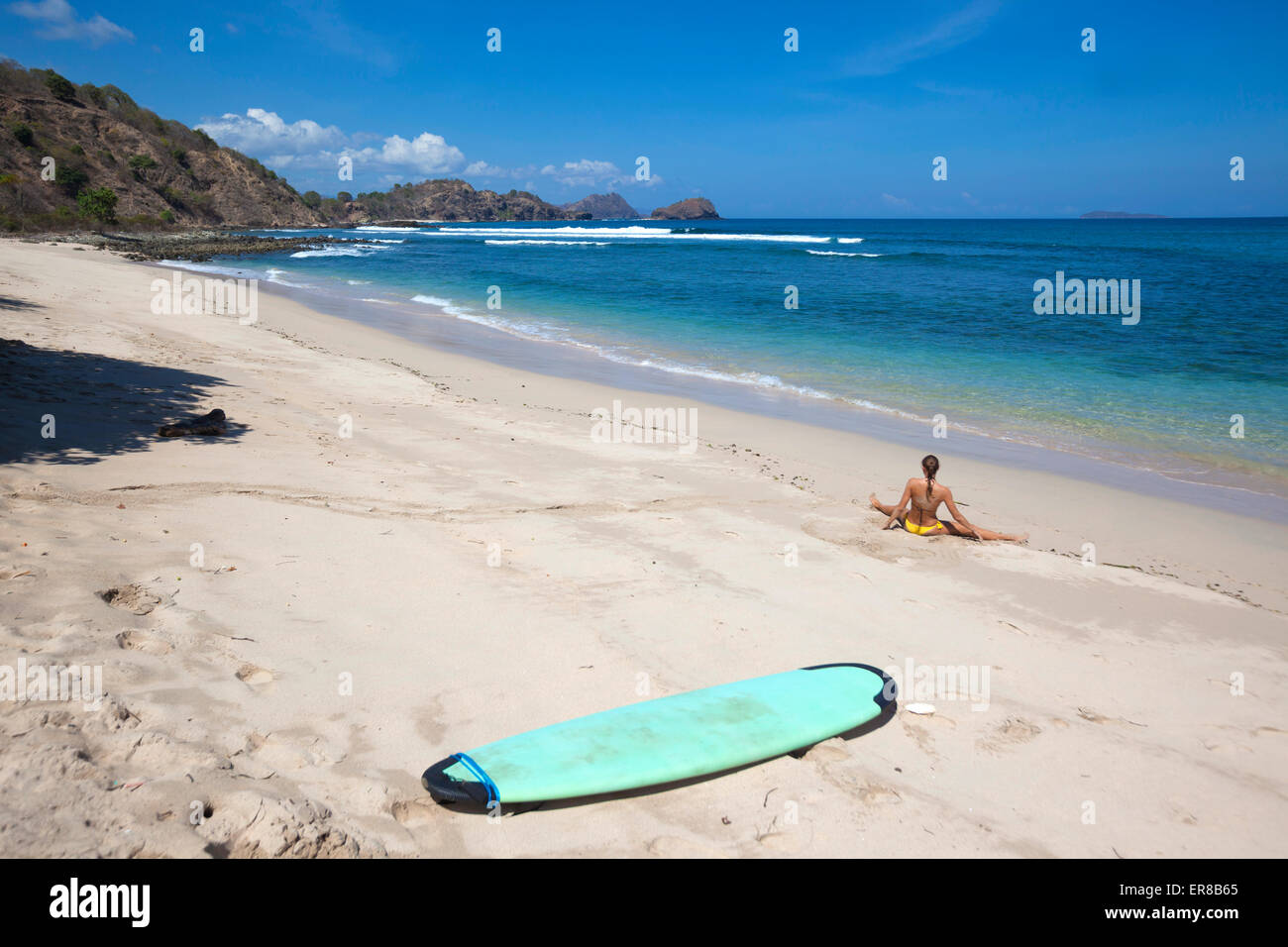 Rear view of woman stretching on beach hi-res stock photography and ...