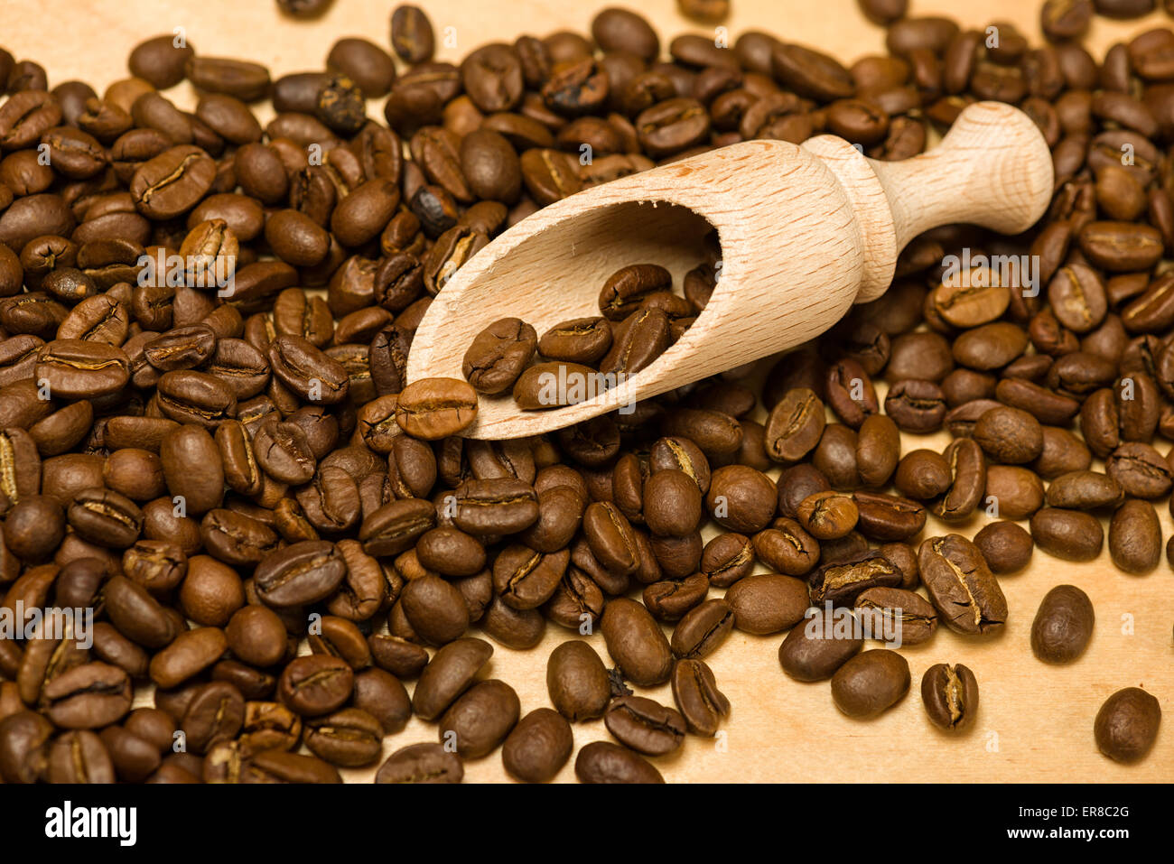 coffee seeds with wooden shovel on wood background Stock Photo - Alamy