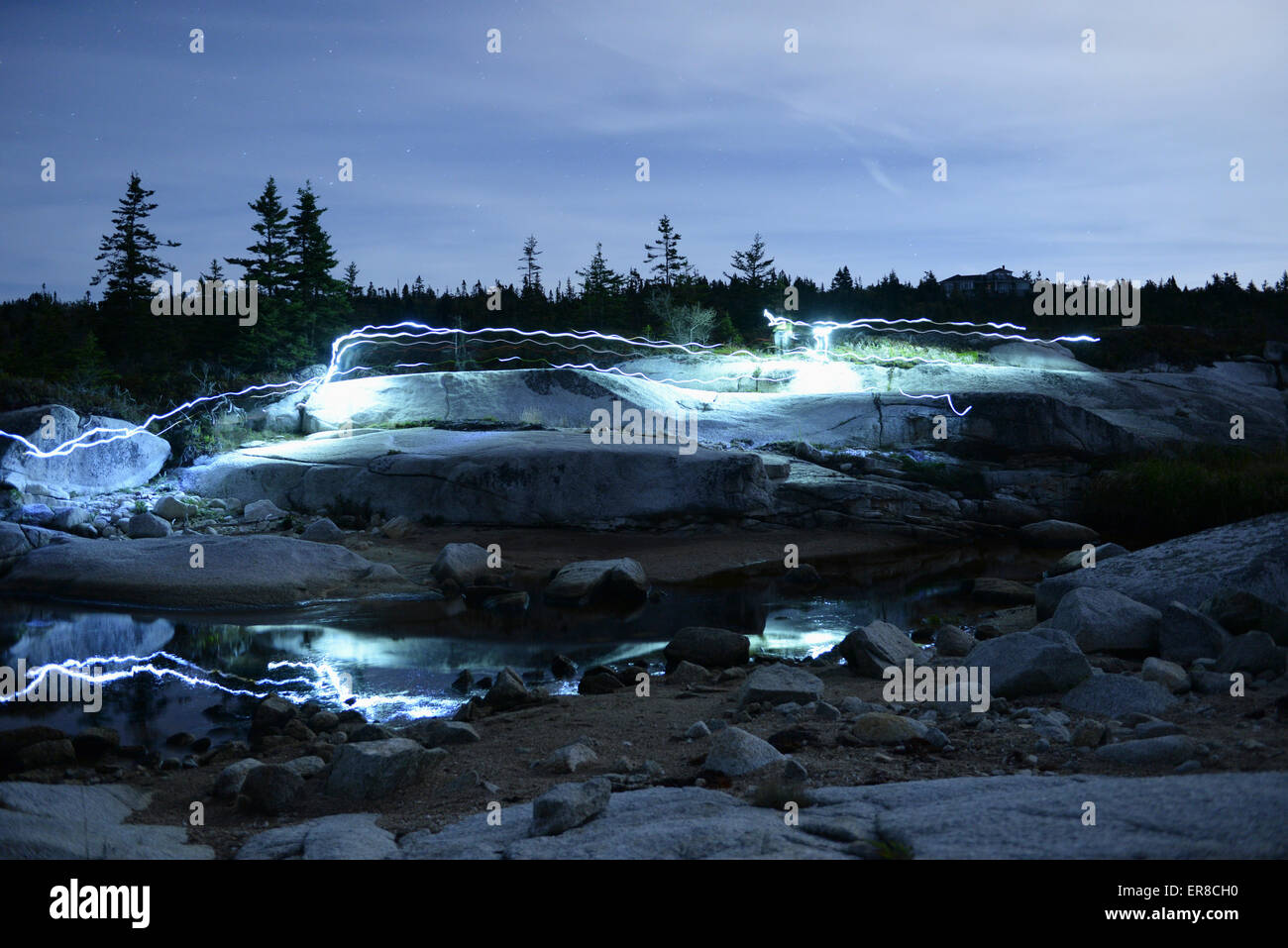 Light trails on rocky landscape Stock Photo - Alamy