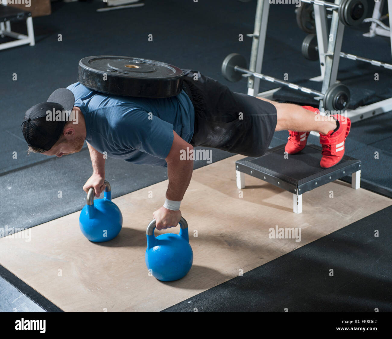 Full length of young man exercising in gym Stock Photo - Alamy