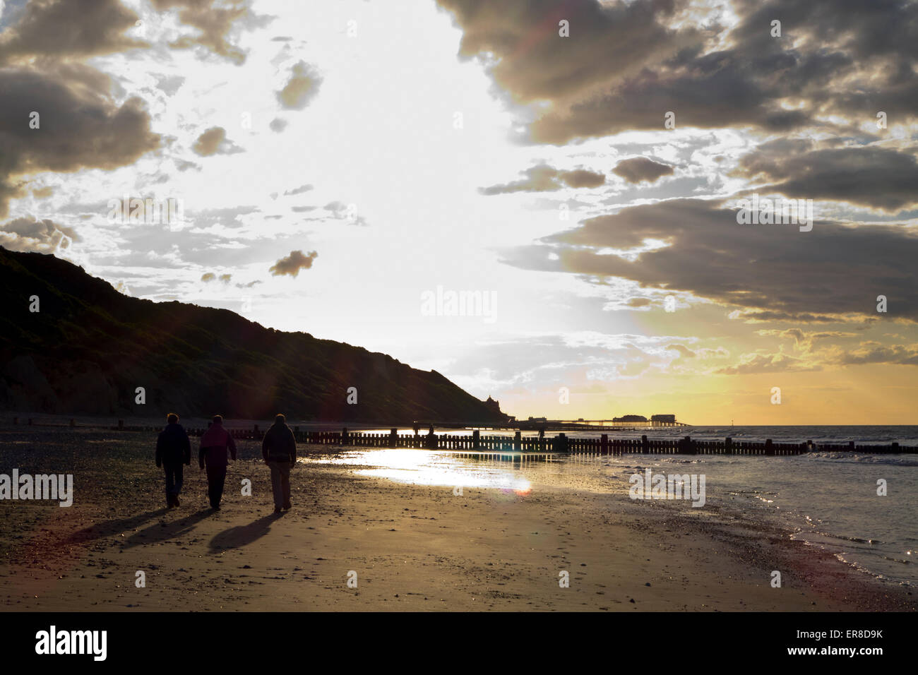 Walk on beach sunset walkers Stock Photo - Alamy