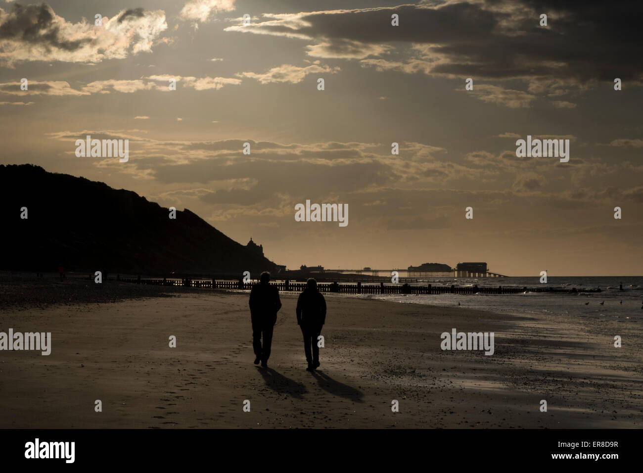 Walk on beach sunset walkers Stock Photo - Alamy