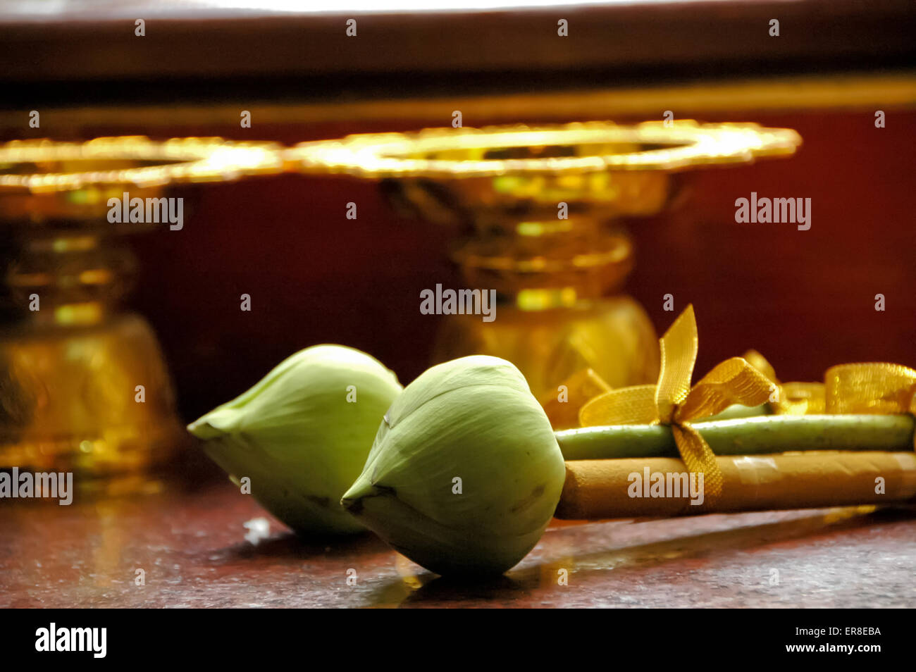 Double lotus and candle offering in Thai temple Stock Photo - Alamy
