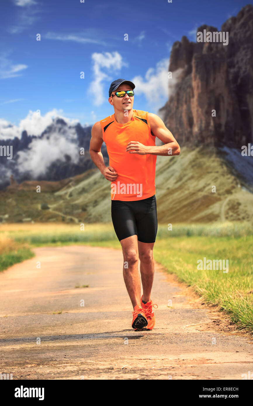 young man jogging through the fields Stock Photo - Alamy