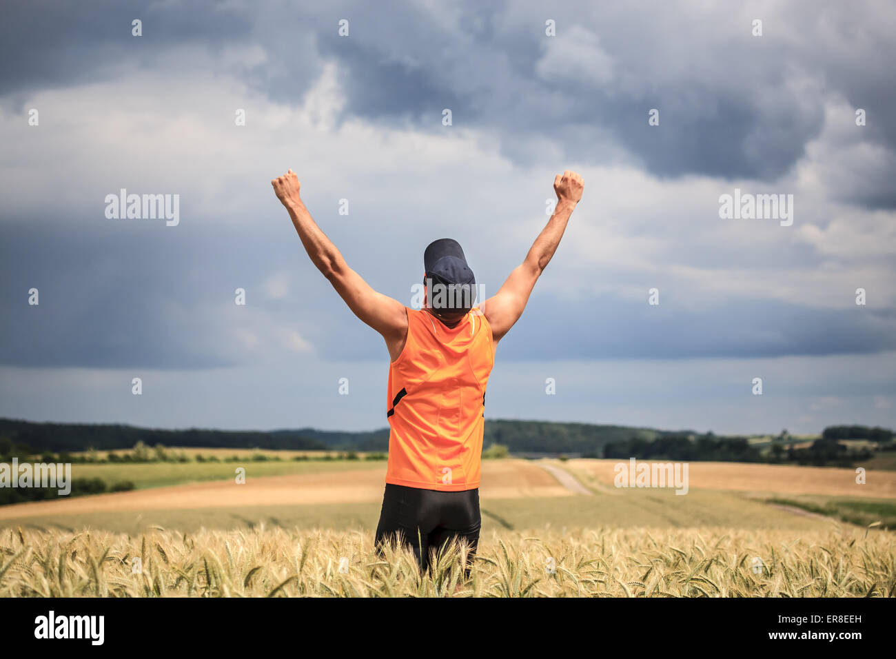 young man jogging through the fields Stock Photo - Alamy