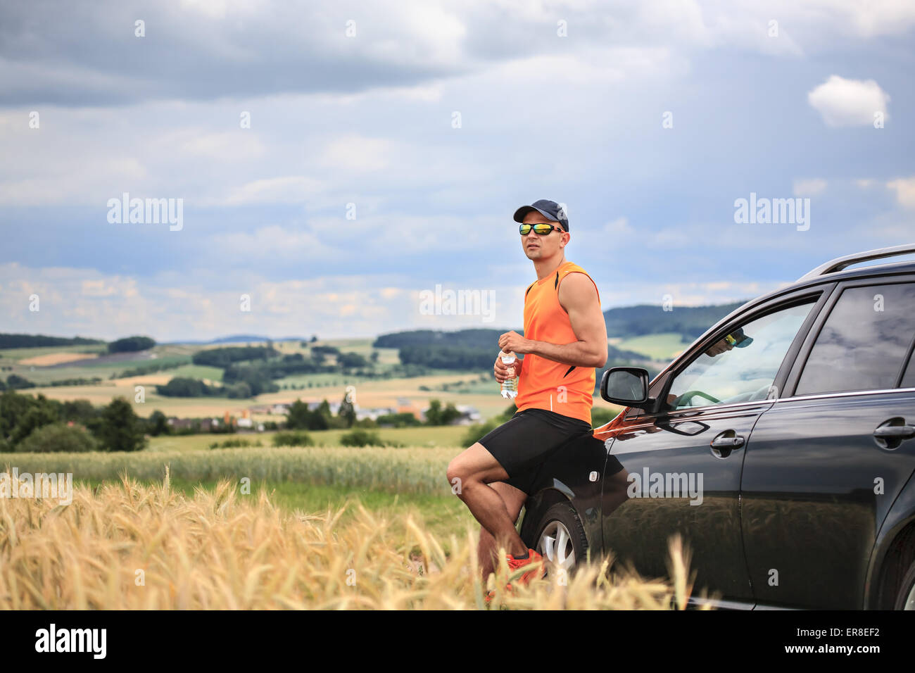 young man jogging through the fields Stock Photo - Alamy