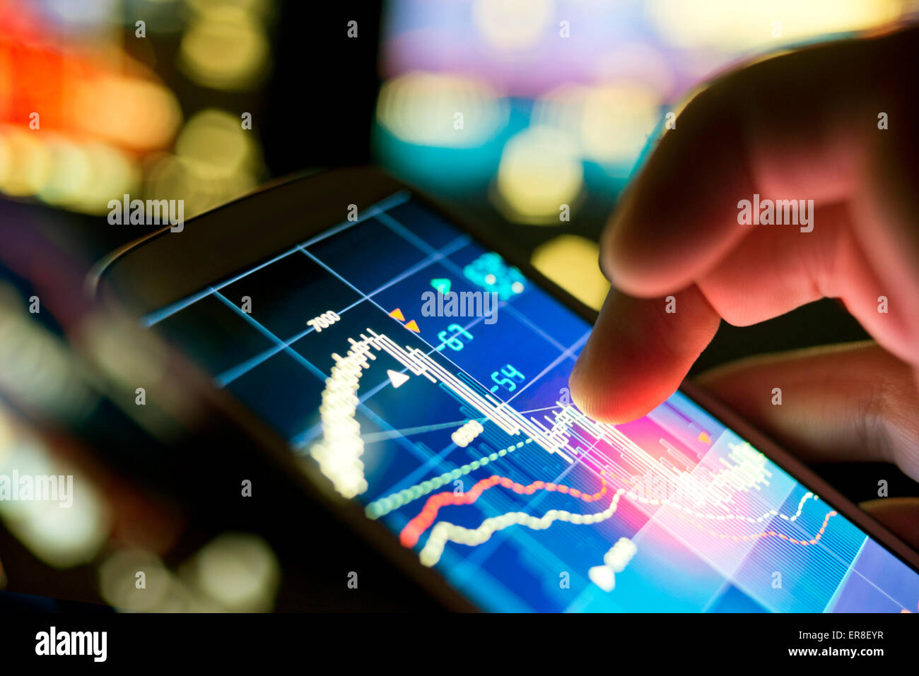 A businessman using a mobile phone to check stock market data Stock ...