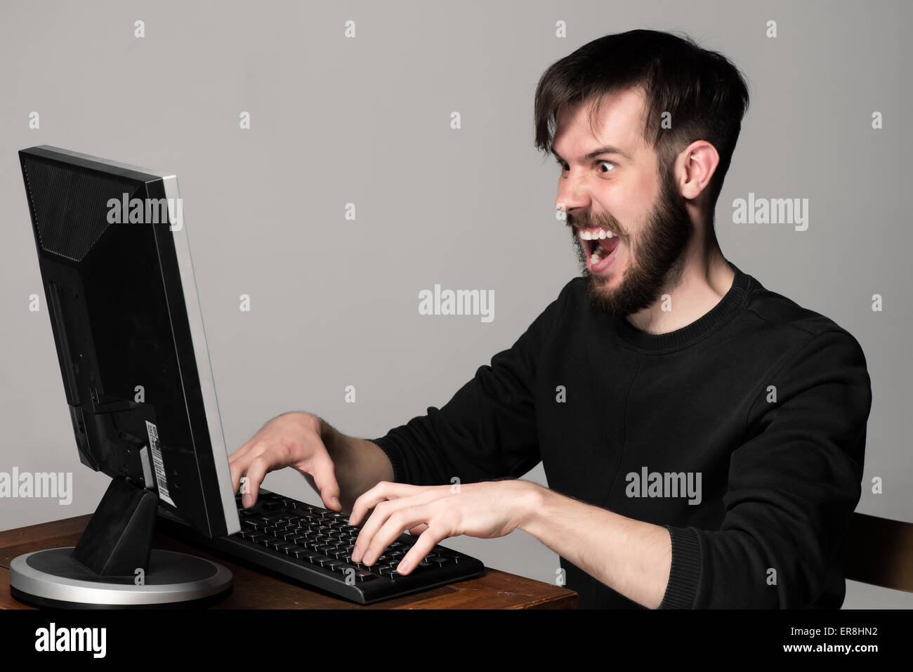 Funny and crazy man using a computer Stock Photo - Alamy