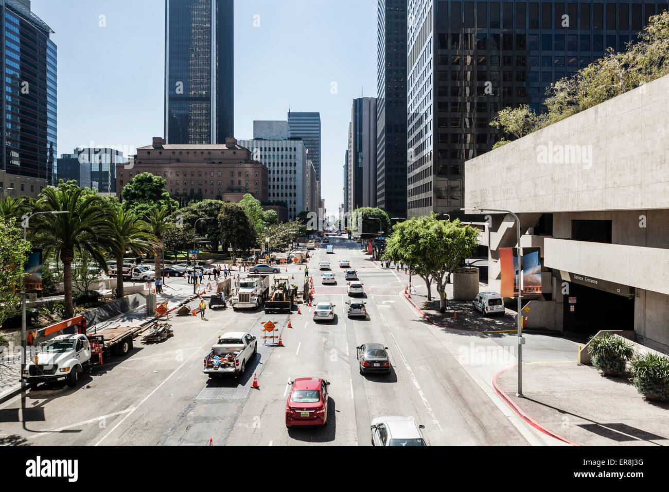 Cars on city street leading towards skyscrapers Stock Photo - Alamy
