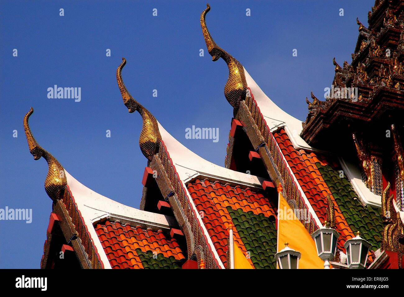 Bangkok, Thailand: Gilded bird-like chofah ornaments atop a colourful ...