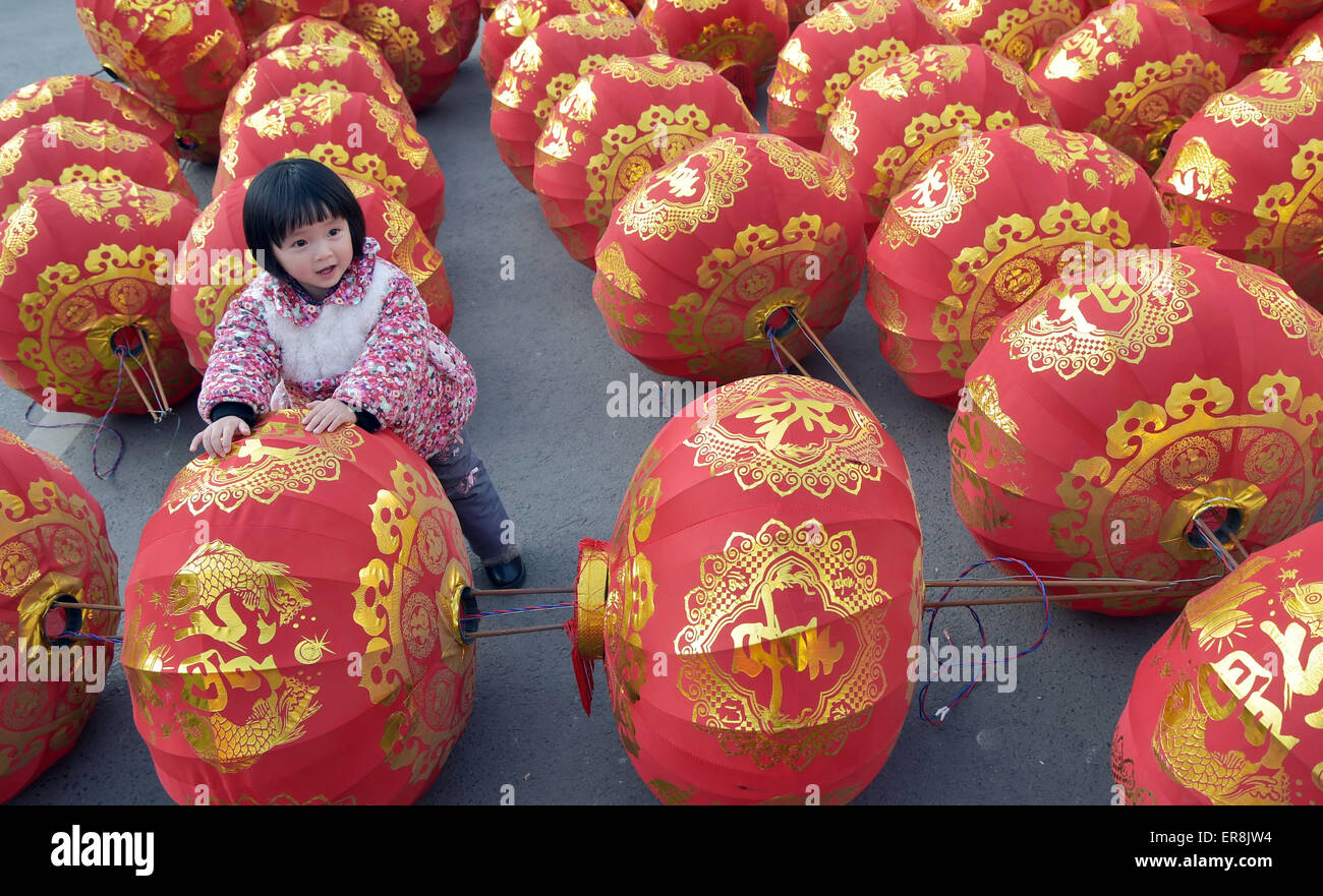 A Chinese is playing between red lanterns for upcoming Chinese Spring ...