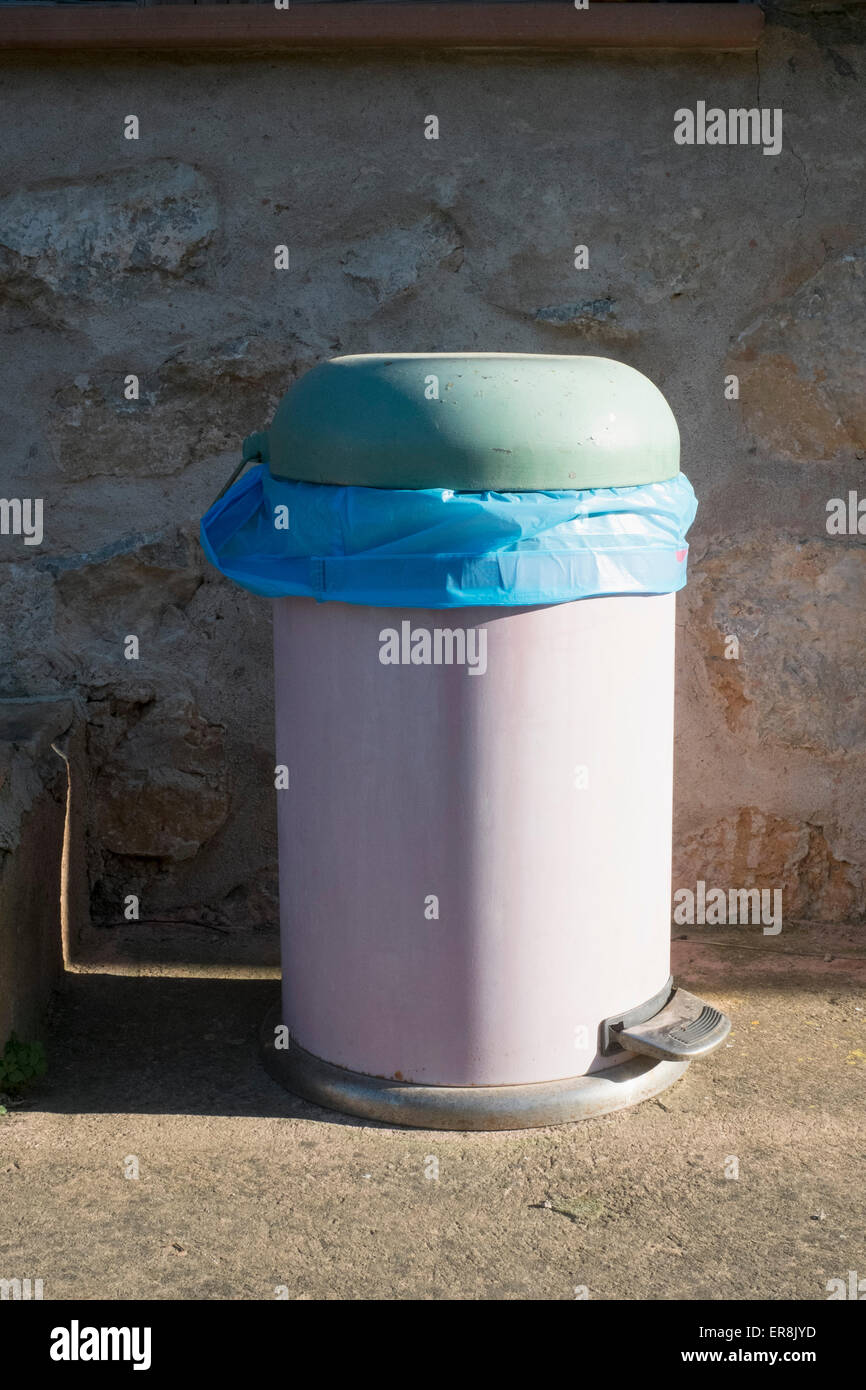 Dustbin against wall Stock Photo - Alamy