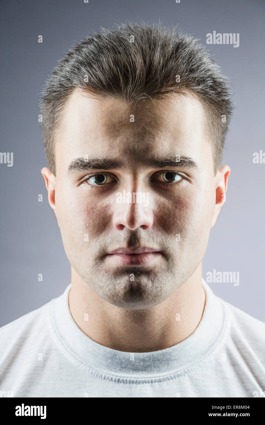 Portrait of handsome young man over gray background Stock Photo - Alamy