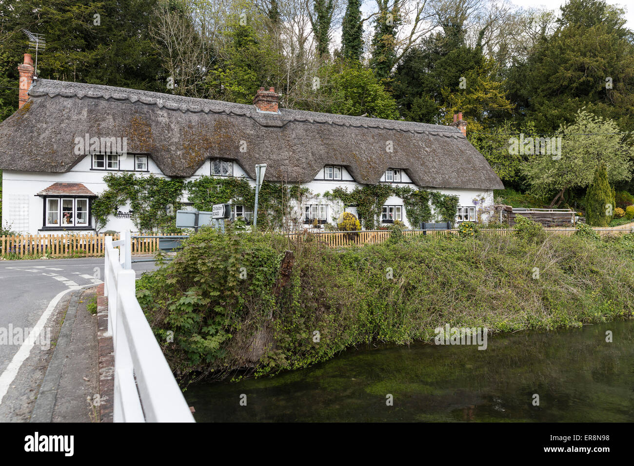 Thatched cottages by River Test, Wherwell, Hampshire, England, UK Stock ...