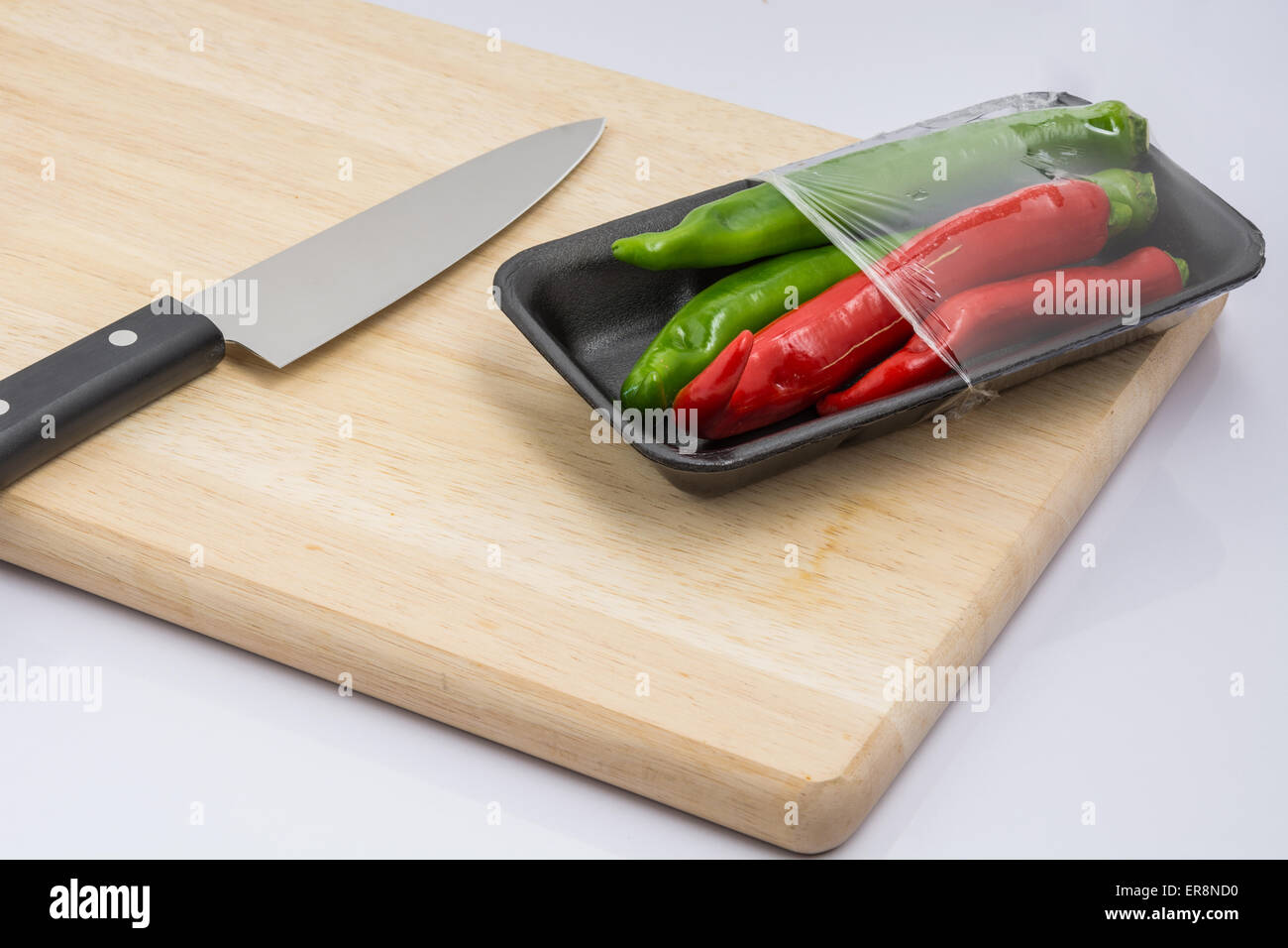Peppers on the chopping block from the supermarket Stock Photo - Alamy
