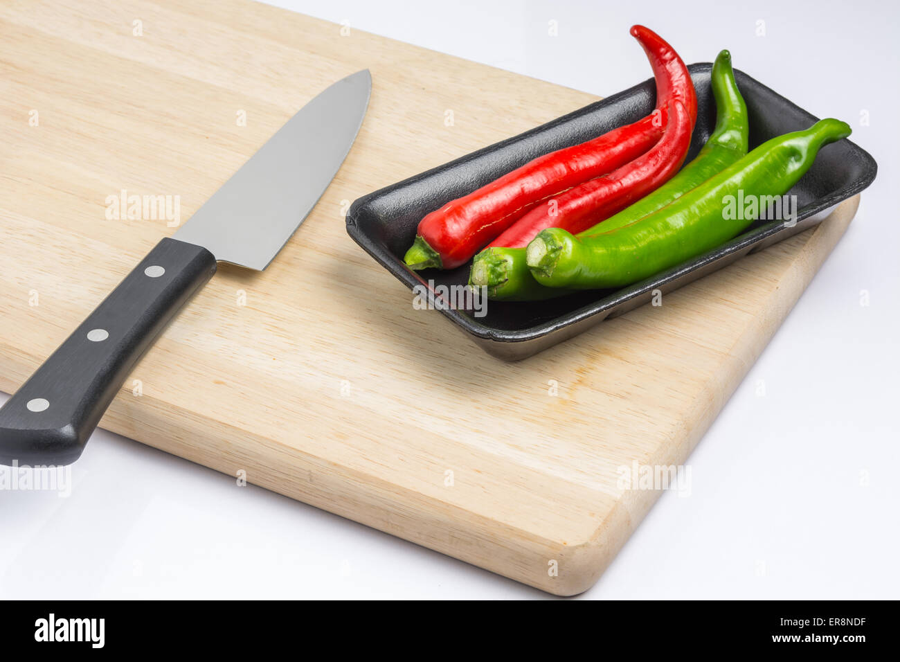 Peppers on the chopping block from the supermarket Stock Photo - Alamy