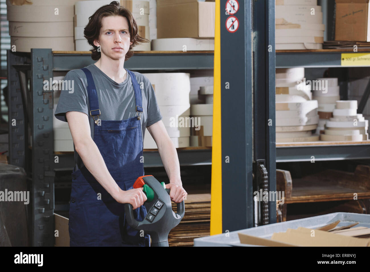 Portrait of young male worker working in warehouse Stock Photo - Alamy